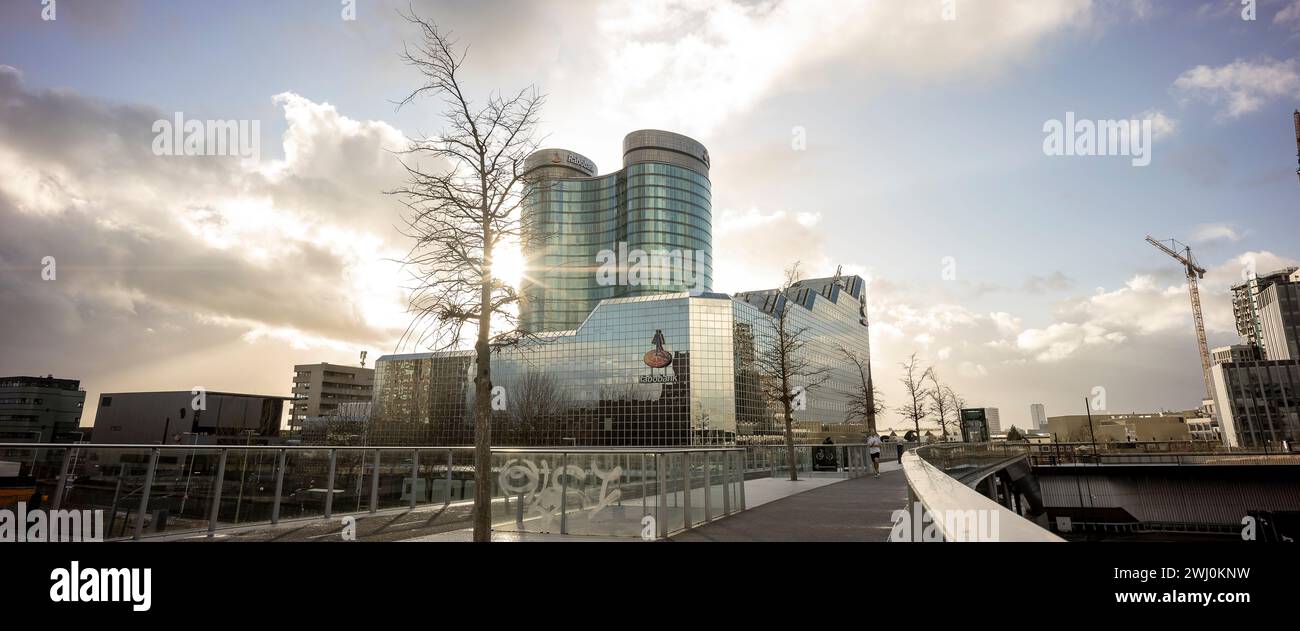 Dark moody high rise buildings around central infrastructure train ...