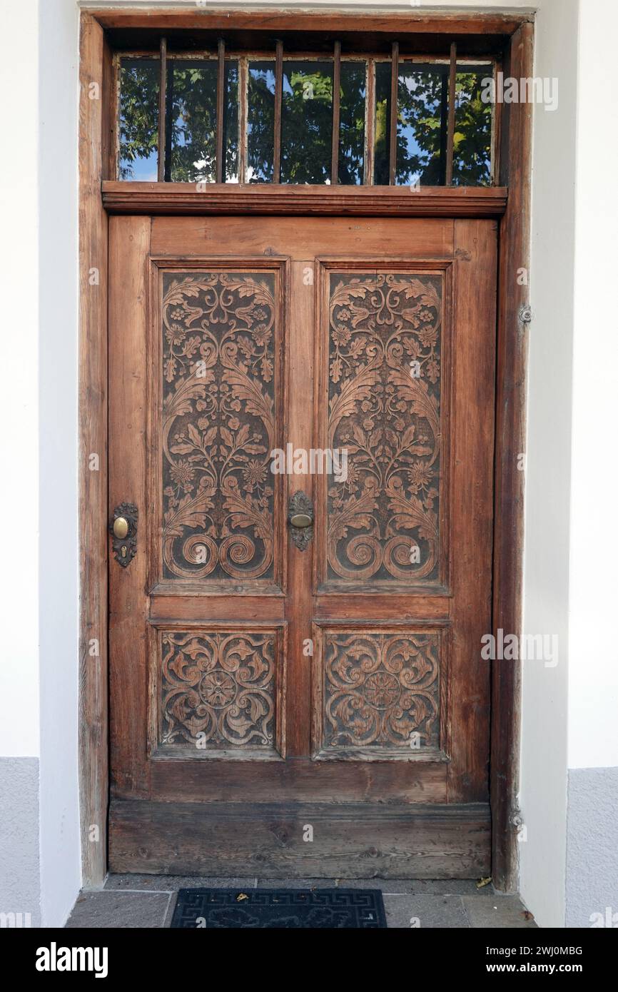 Richly decorated wooden door on a listed building Stock Photo - Alamy