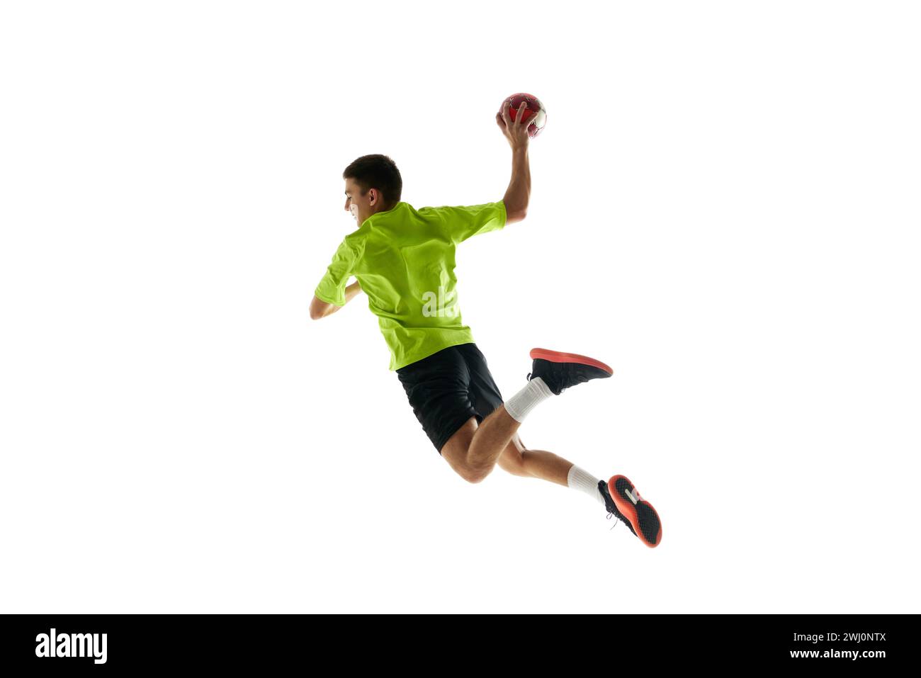 Competitive and concentrated young guy, handball player in motion ...
