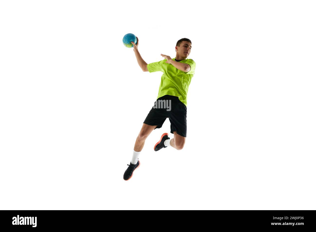 Dynamic image of young man in uniform, handball player in motion during ...
