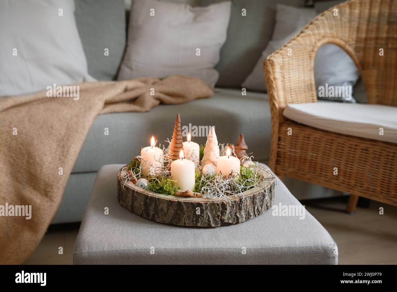 Christmas or advent decoration with white candles in a rustic tree ...