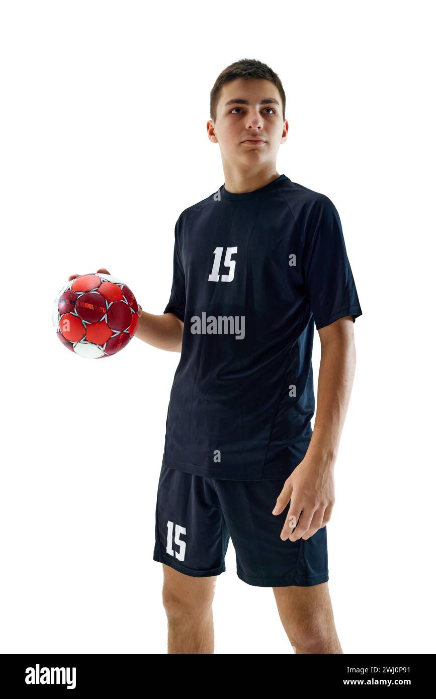 Concentrated young man, athlete in dark uniform, handball player ...