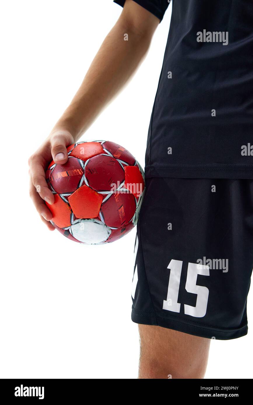 Cropped image f male hand holding handball ball against white studio ...