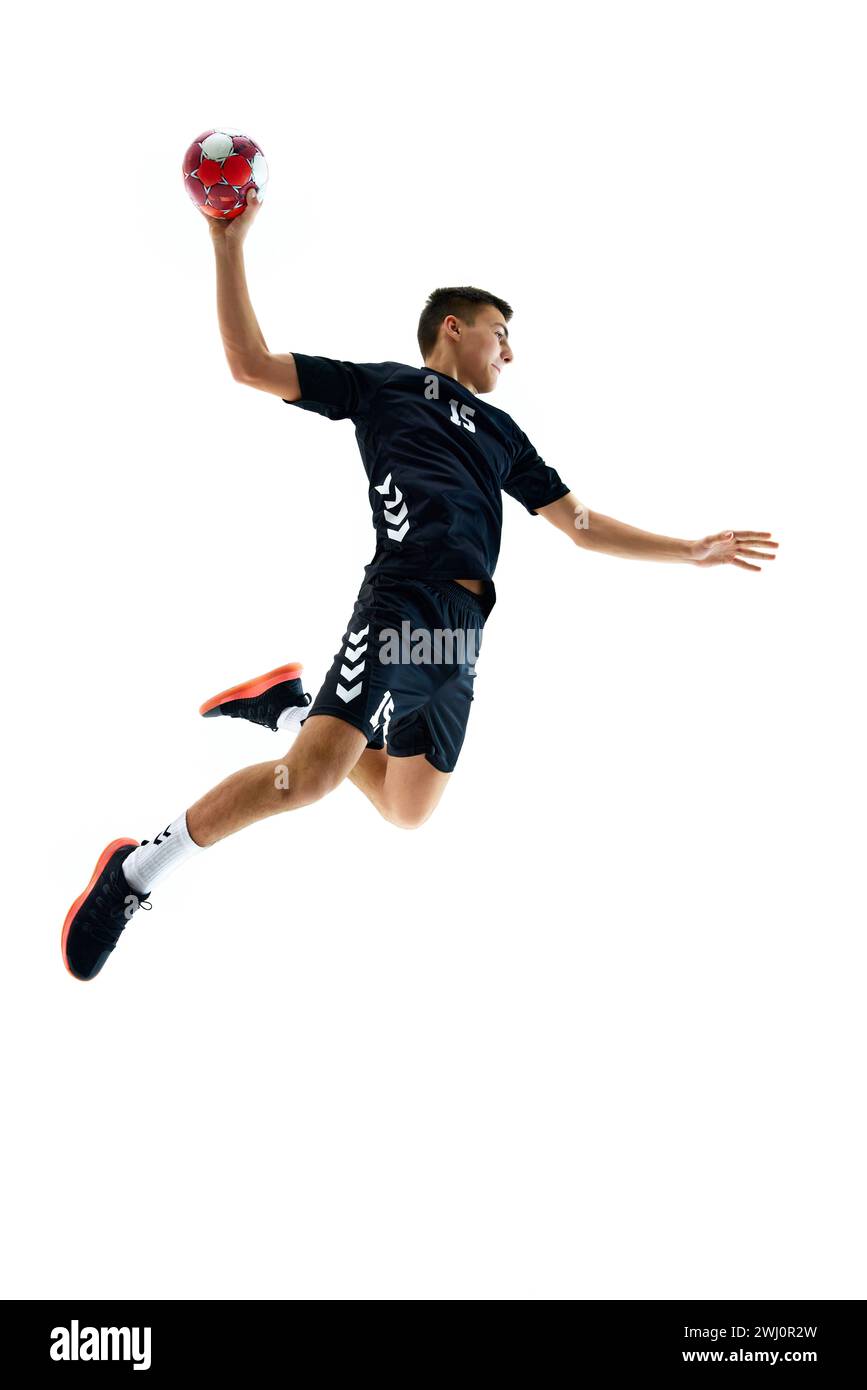 Full-length image of young handball athlete in motion during game ...