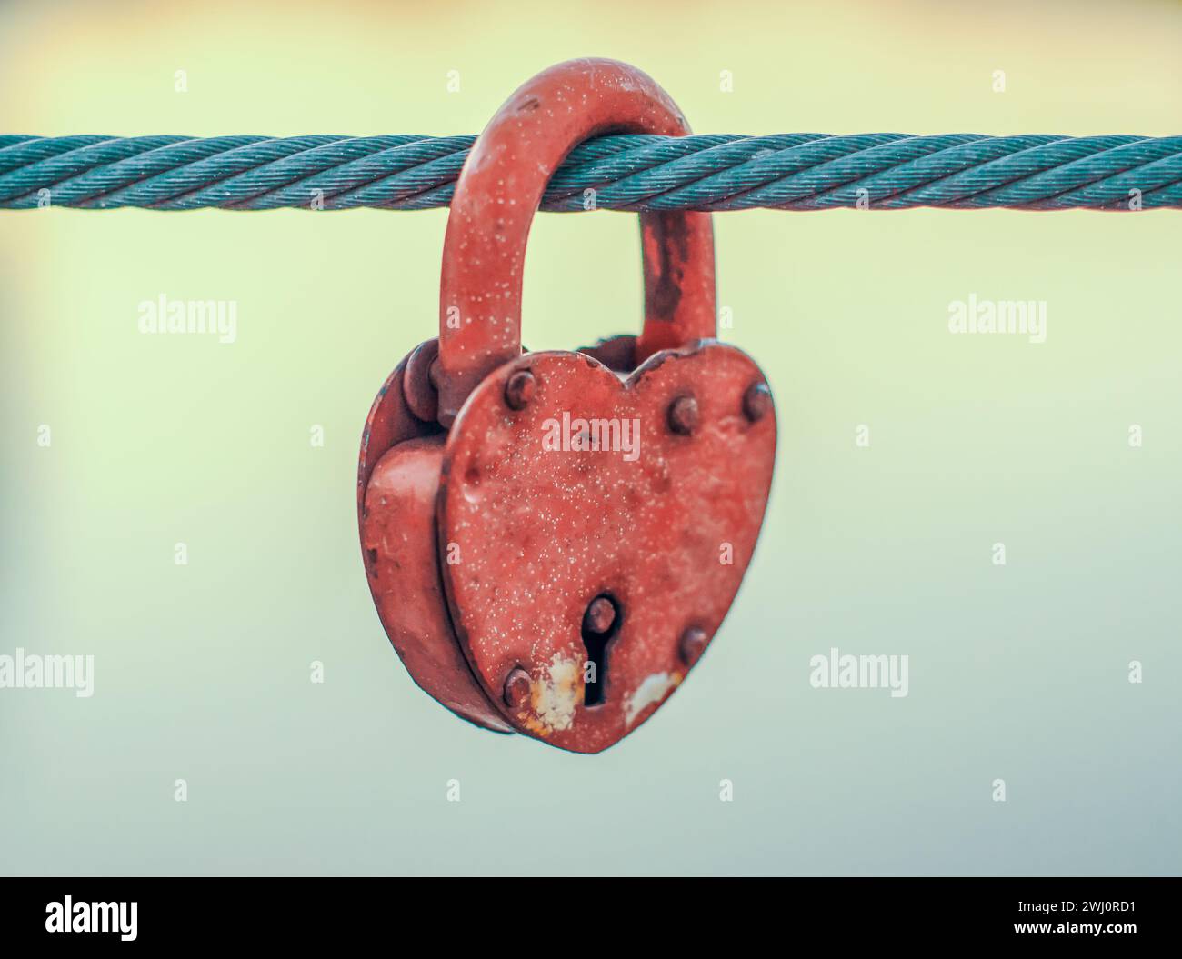 Red peeling wedding lock on a rope with a key hole Stock Photo - Alamy
