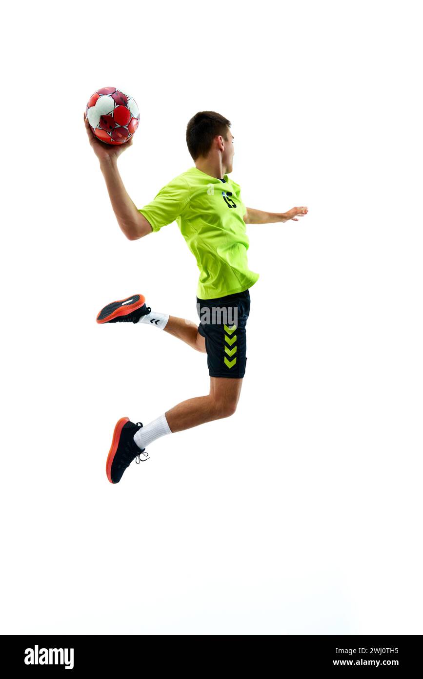 Full-length image of young handball athlete in motion during game ...