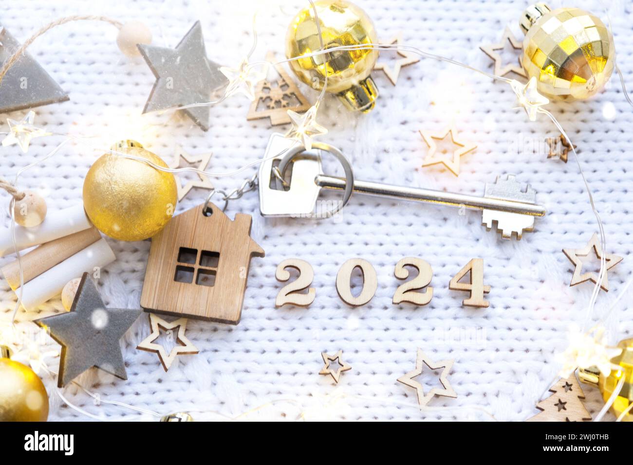 House key with keychain cottage on festive background with stars ...