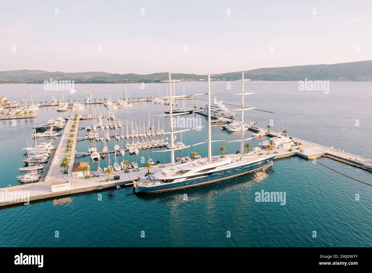 Large yacht with lowered sails stands at the marina pier. Drone Stock ...