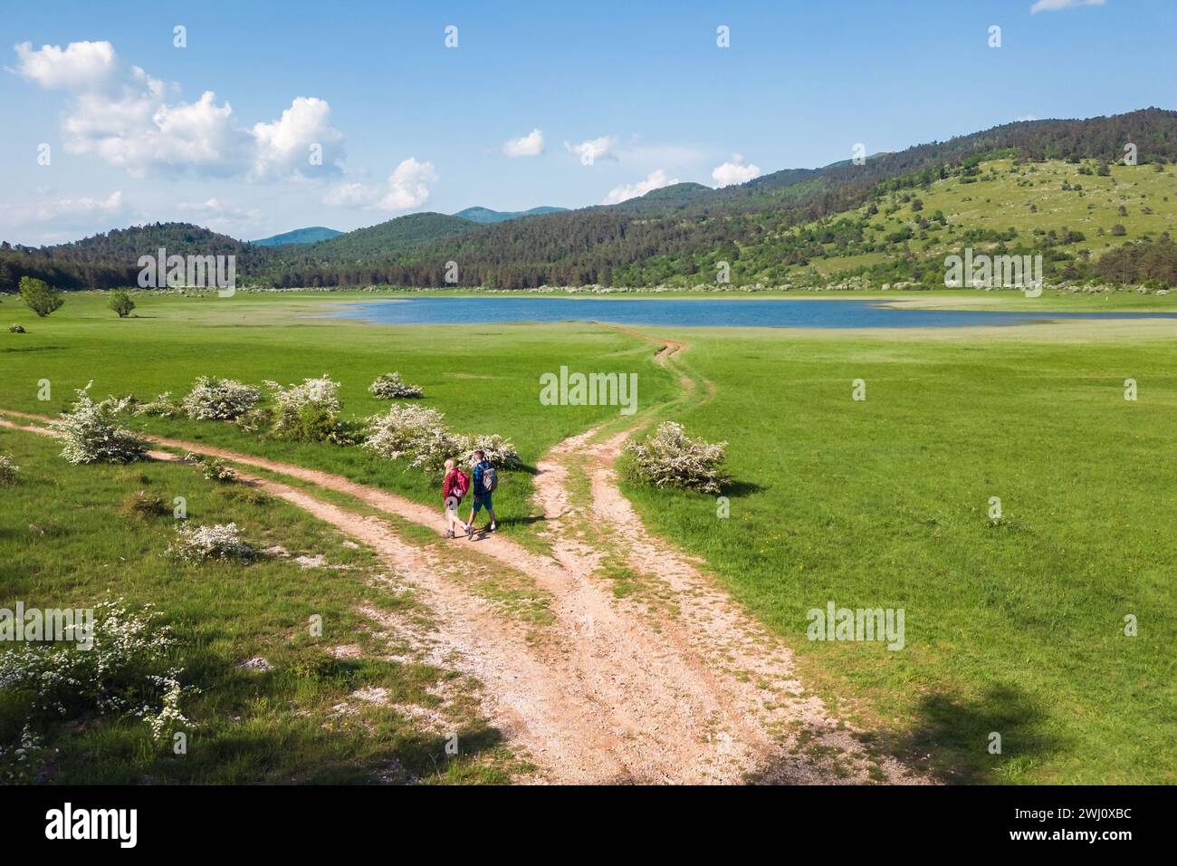 Adolescence blonde girl and a guy enjoying hiking and exploring a ...