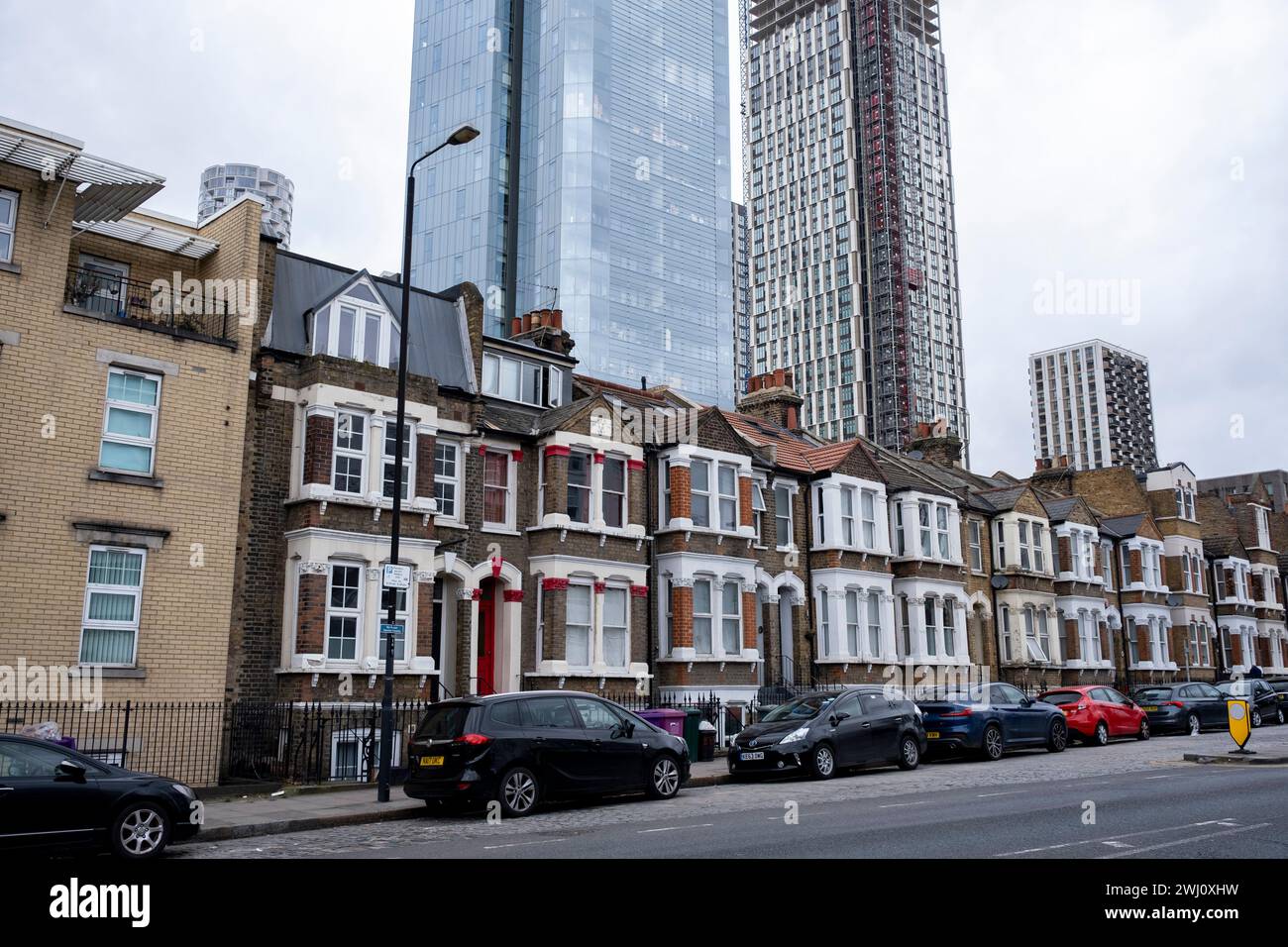 New high rise apartment block towers over an old terrace of low rise ...
