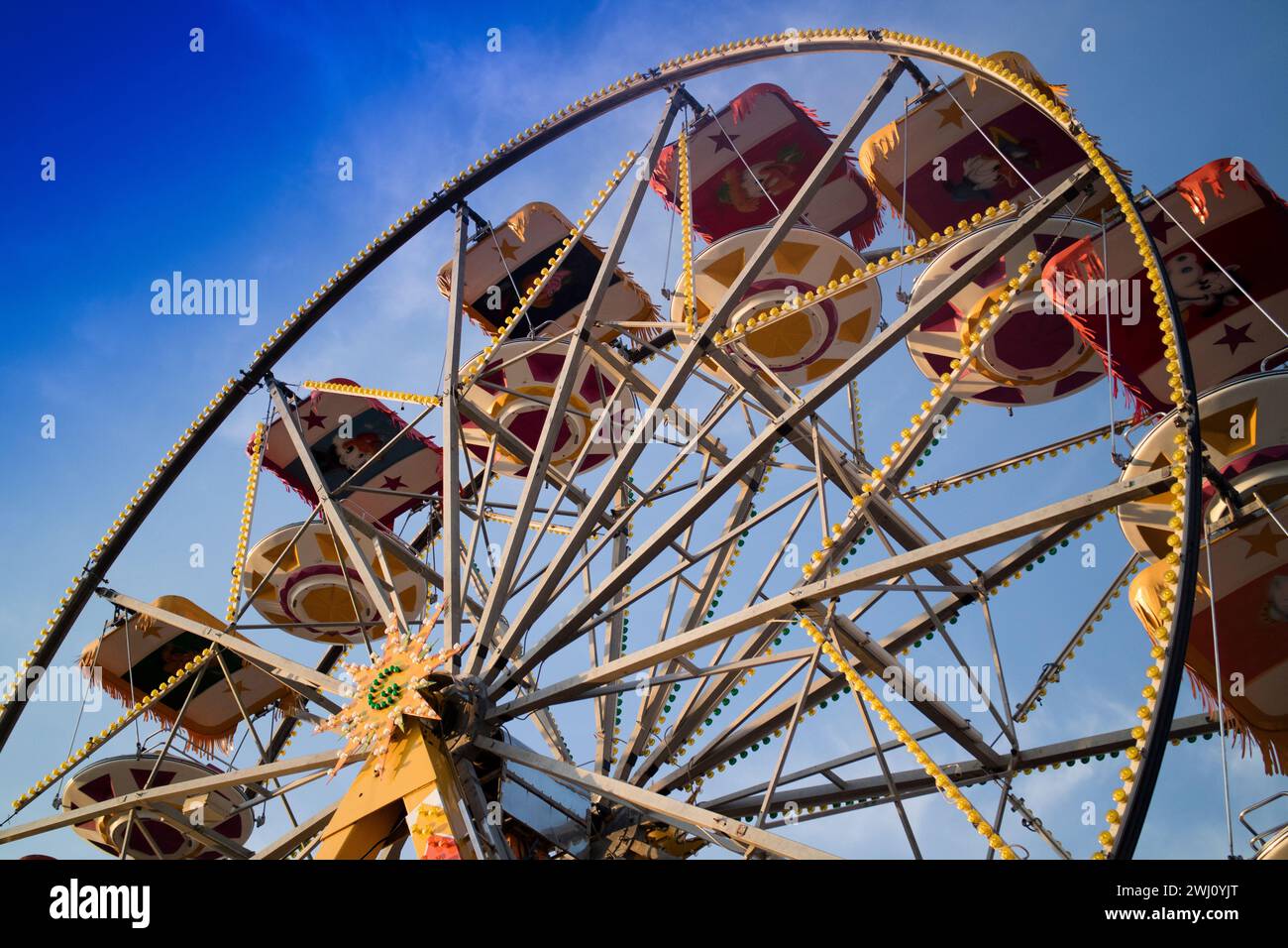 Inside an amusement park the colors of the Ferris wheel Stock Photo - Alamy