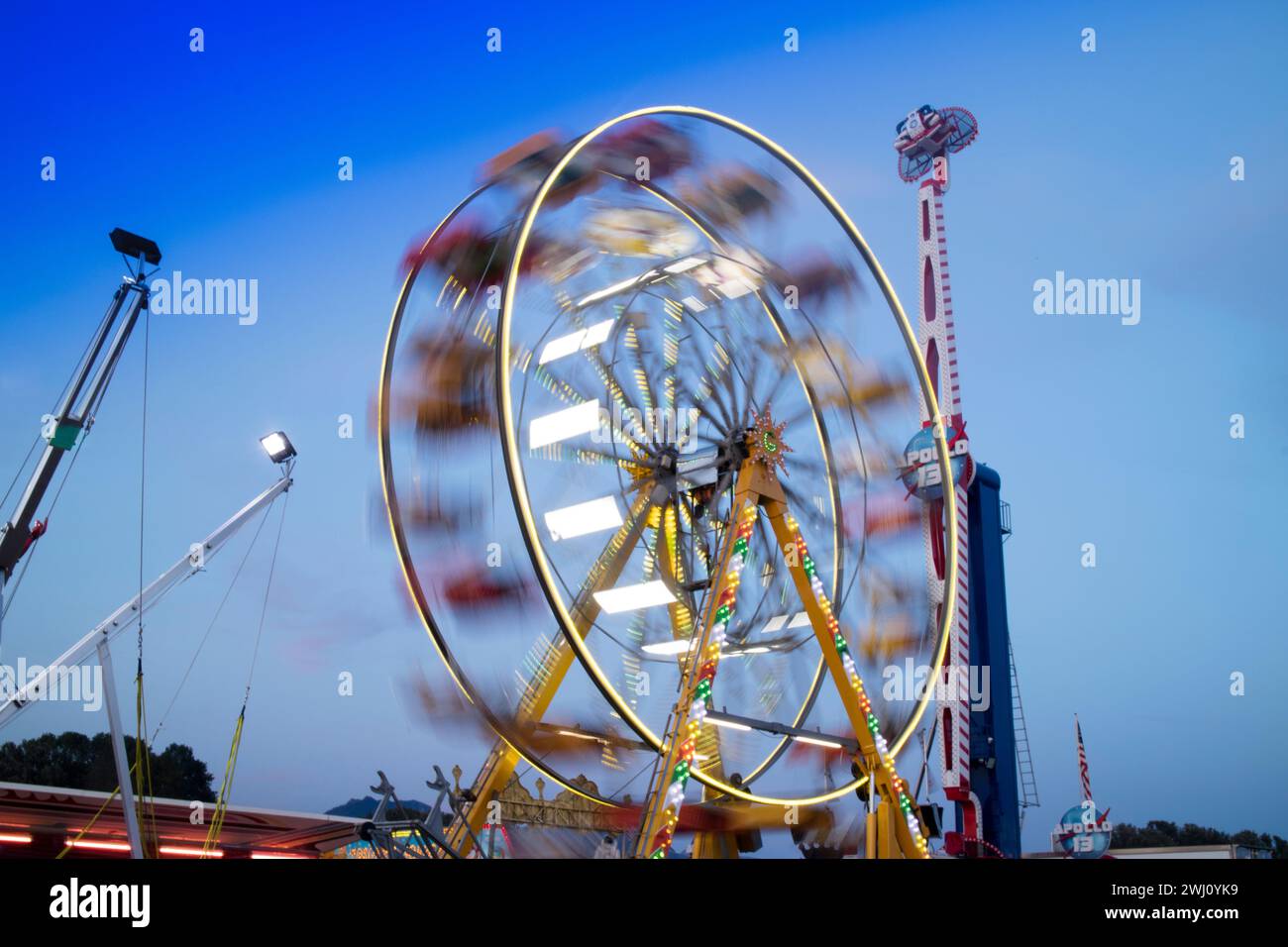 Inside an amusement park the colors of the Ferris wheel Stock Photo - Alamy