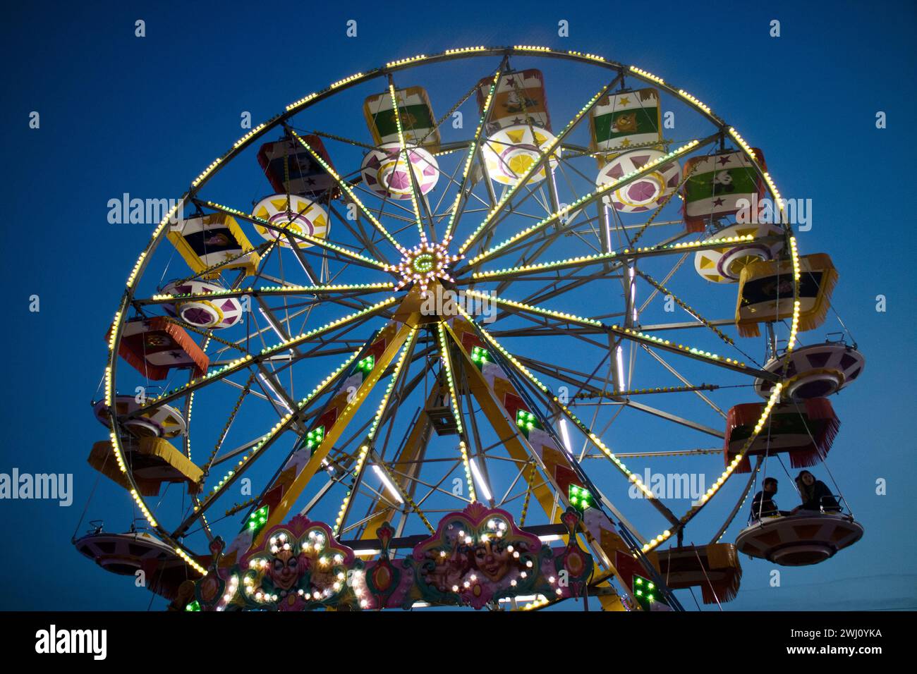 Inside an amusement park the colors of the Ferris wheel Stock Photo - Alamy