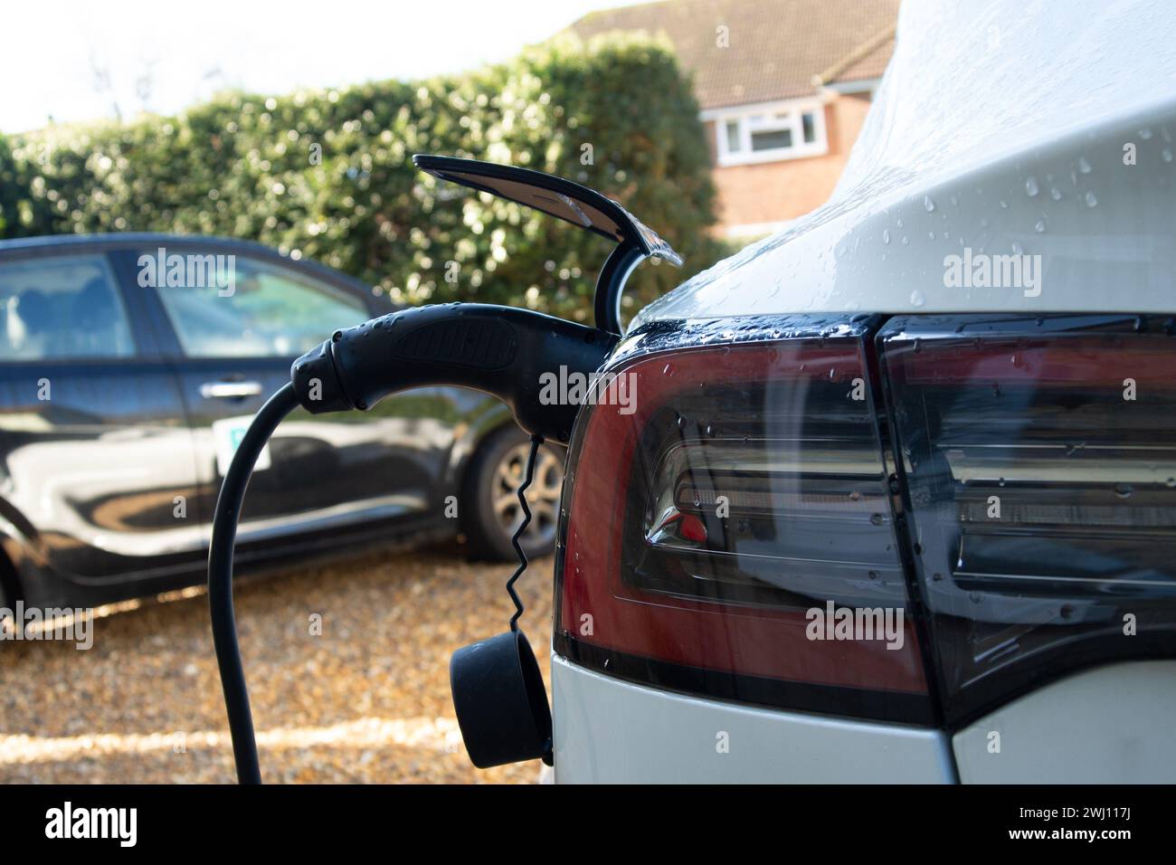 Electric Vehicle Tesla charging at home Stock Photo - Alamy