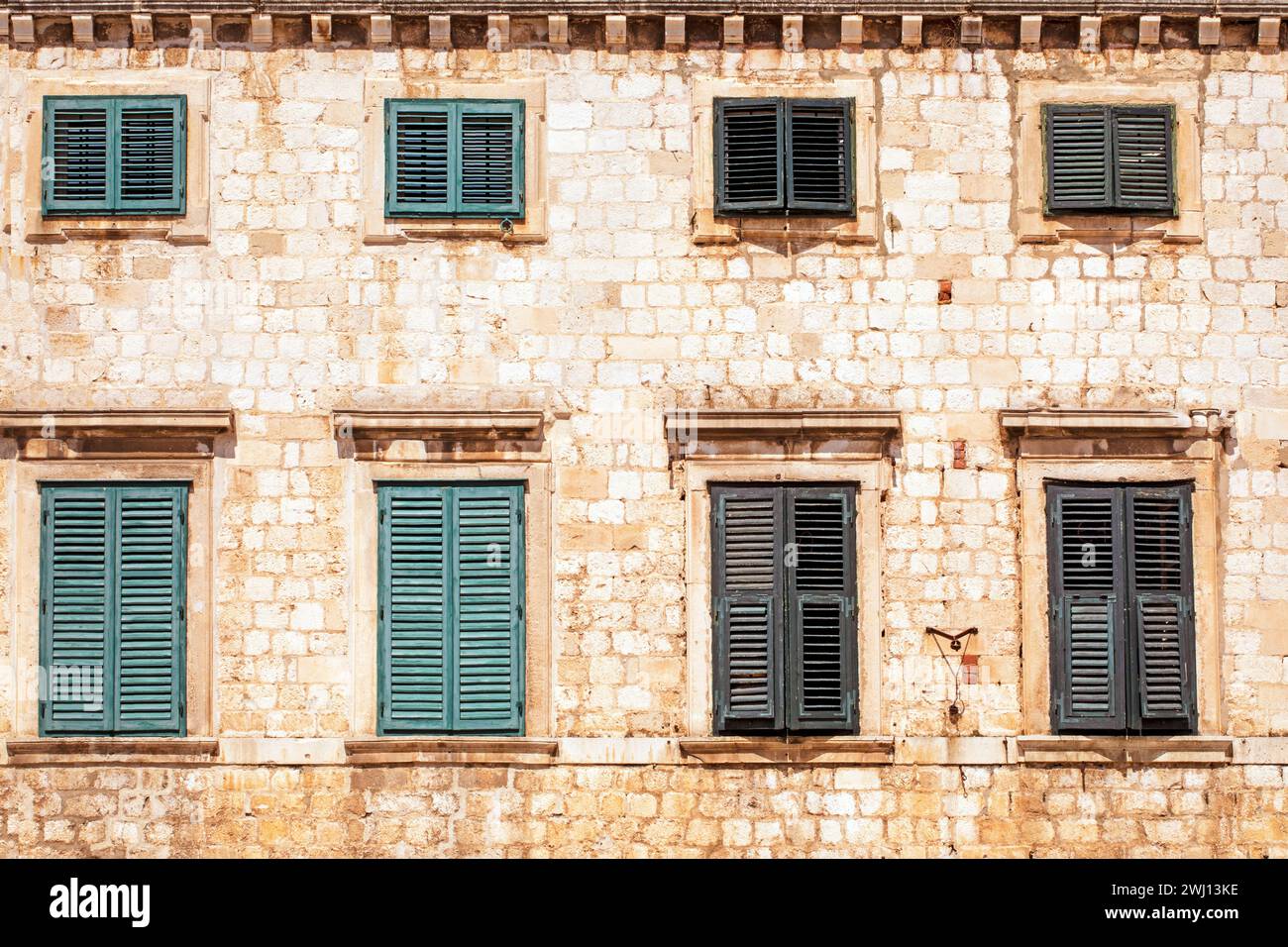 ancient windows with green shutters in an ancient Roman masonry ...