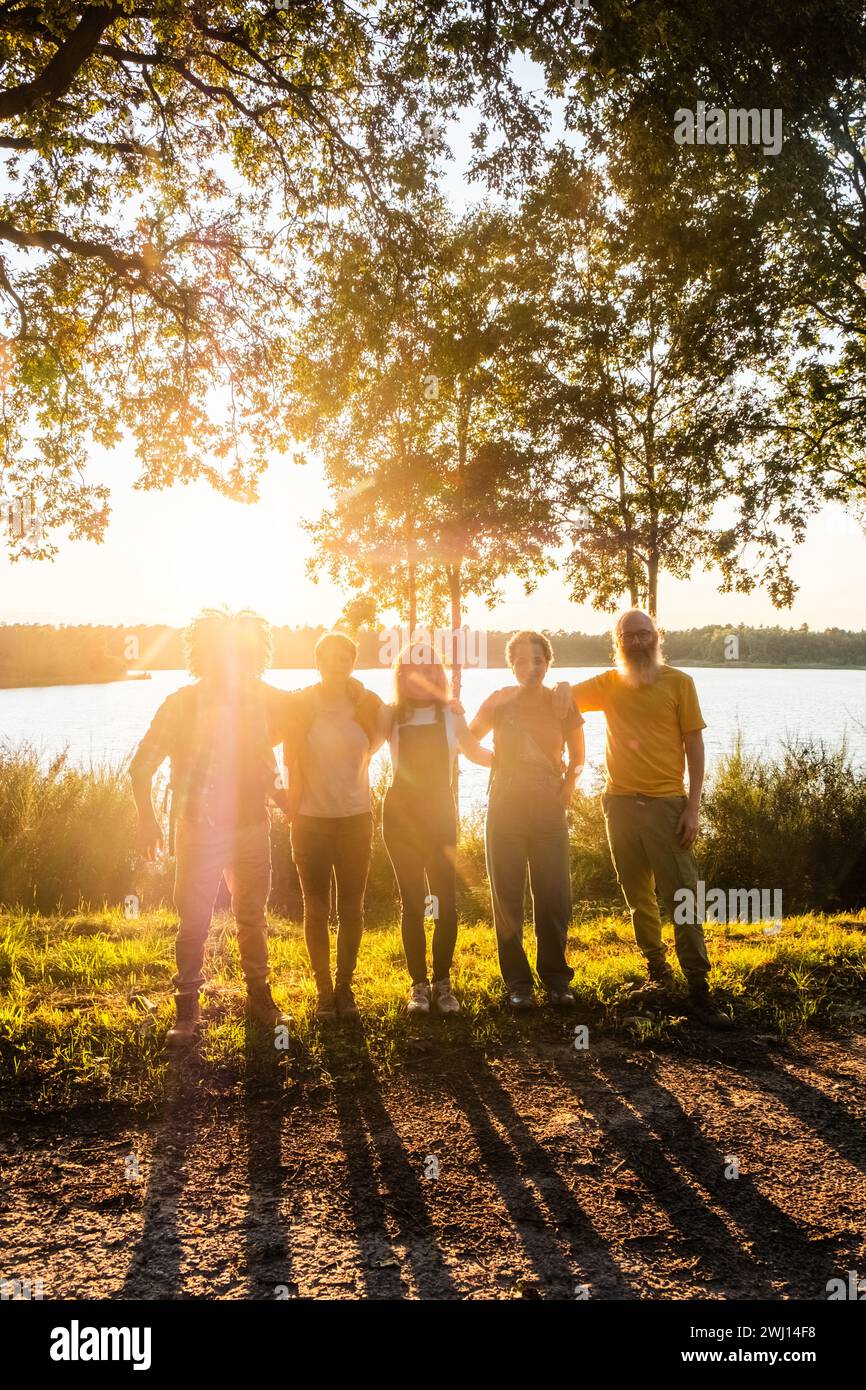 This image exudes the warmth of family unity with a group standing side ...