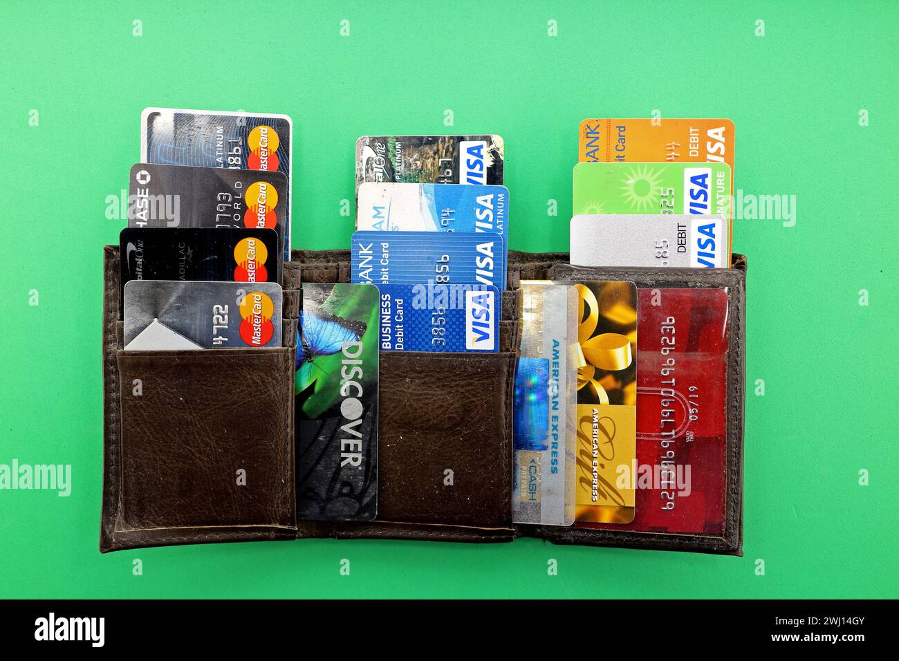 Wallet with many credit cards, on a green background Stock Photo - Alamy