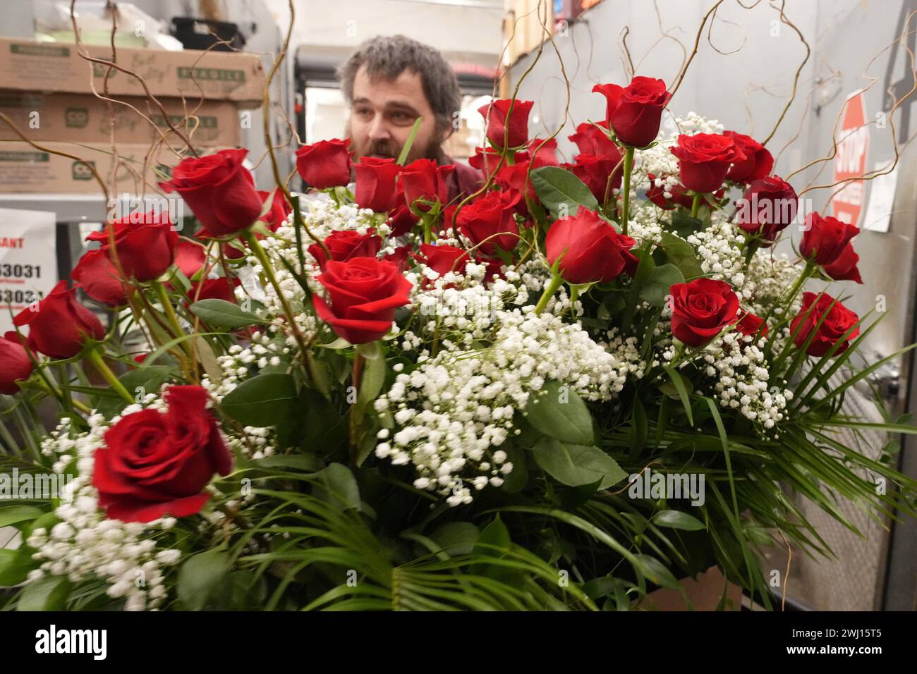 St. Louis, United States. 15th Feb, 2024. A worker wheels a cart full ...