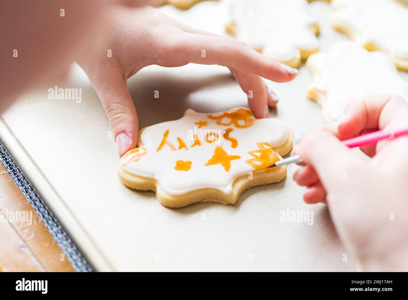 Little Girl Spells 'Sorry' on Iced Sugar Cookies Stock Photo - Alamy