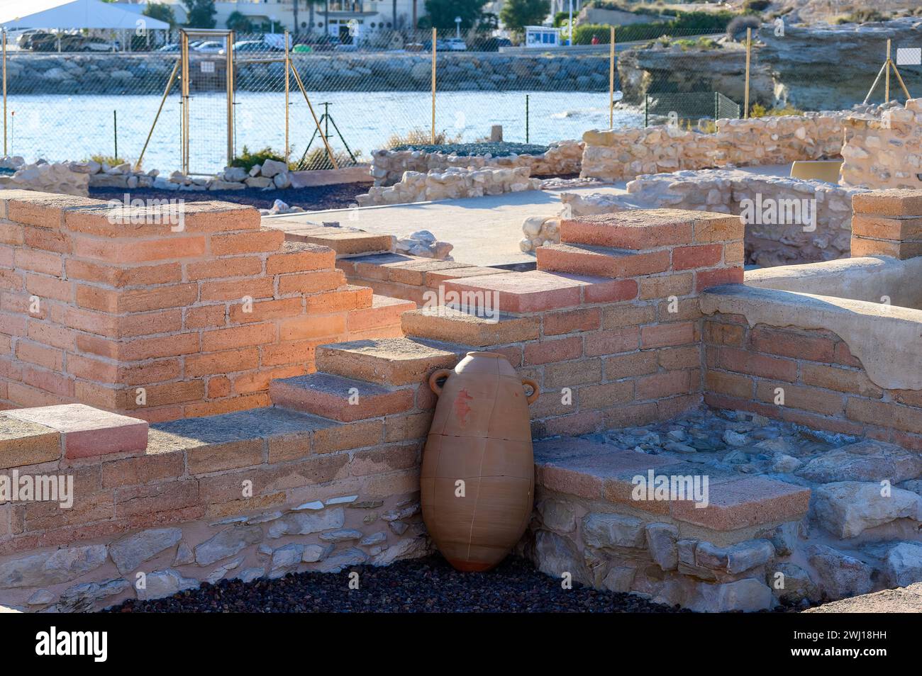 Ancient container leaning against the walls of a building used in the production of wine. La ...