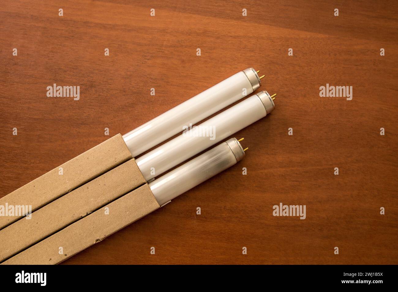 fluorescent lamps on the table, burnt and new Stock Photo - Alamy