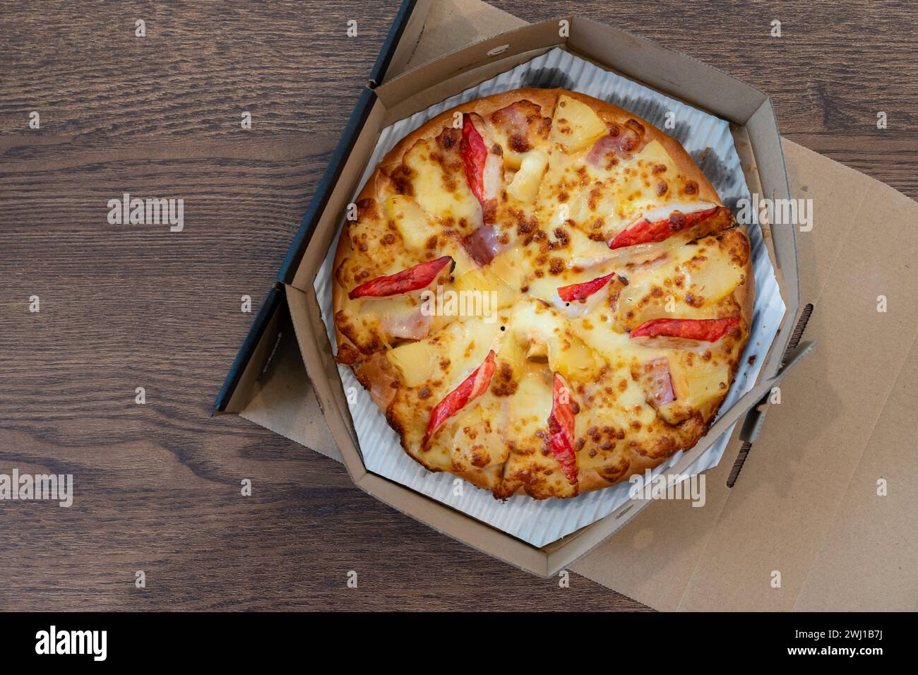 A slice of hot Italian pizza with stretching cheese on the table Stock ...