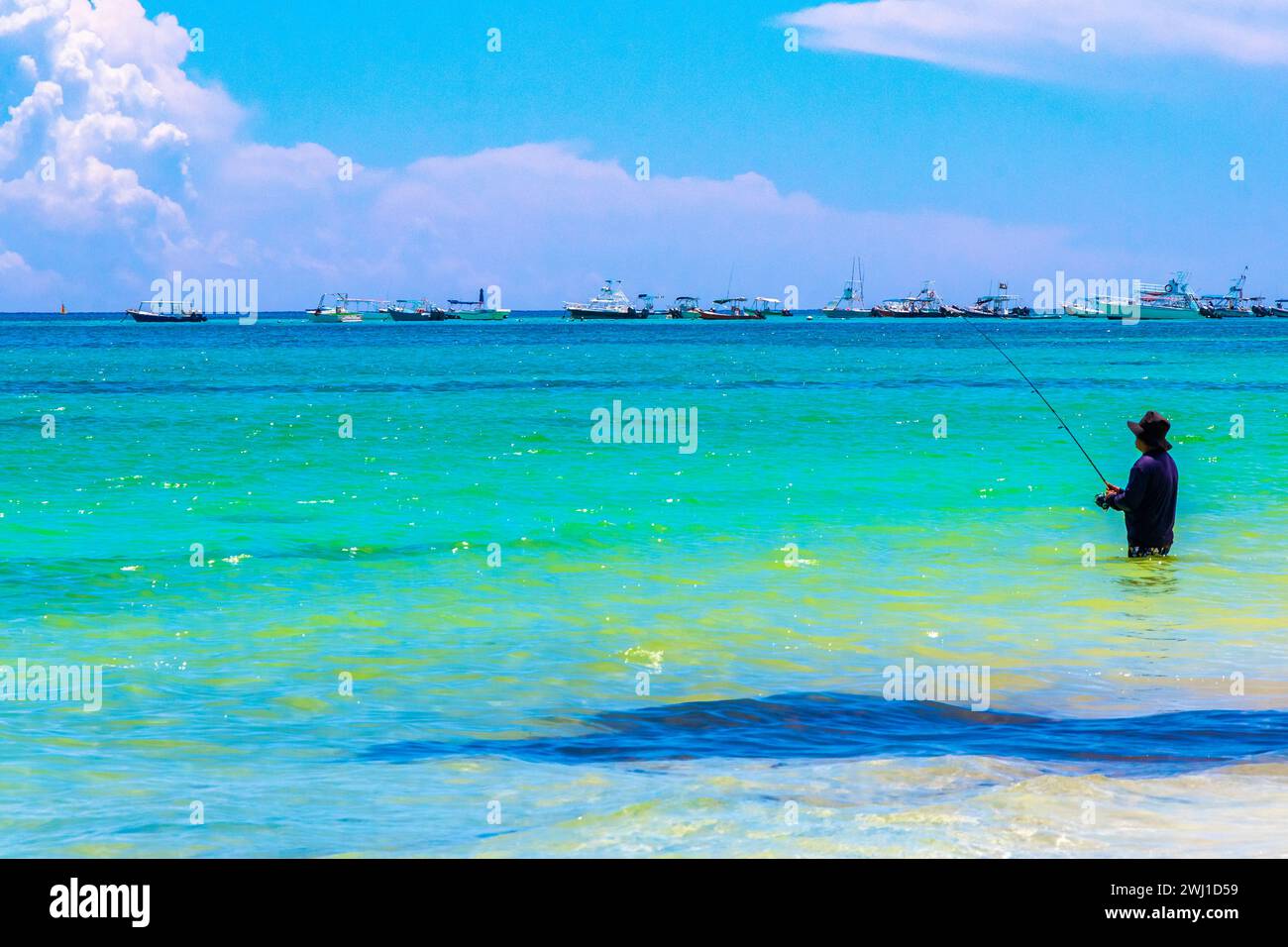 Mexican fisher angler with fishing rod on the Caribbean Sea beach in ...