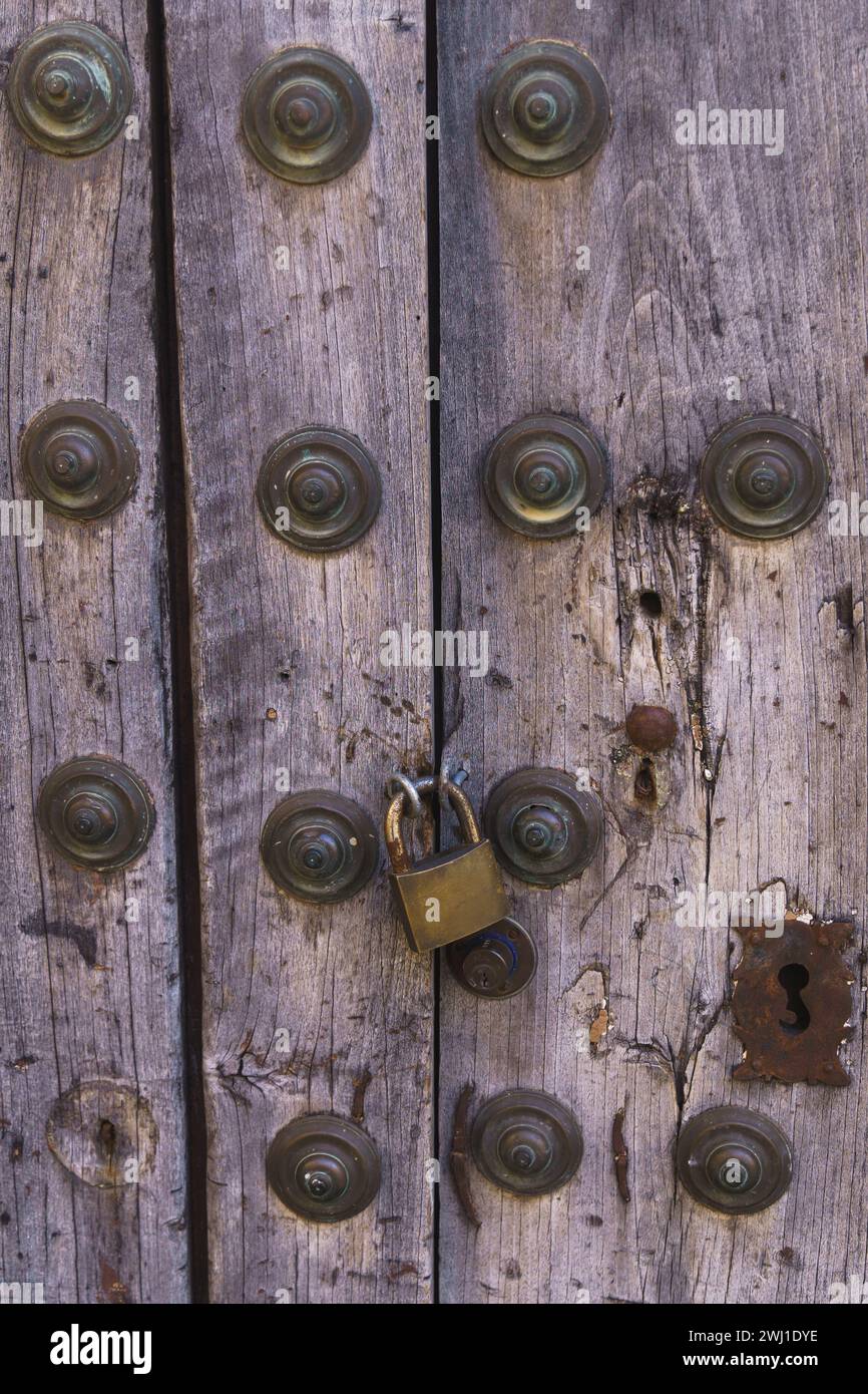 antique wooden door with metal rivets and a padlock Stock Photo - Alamy