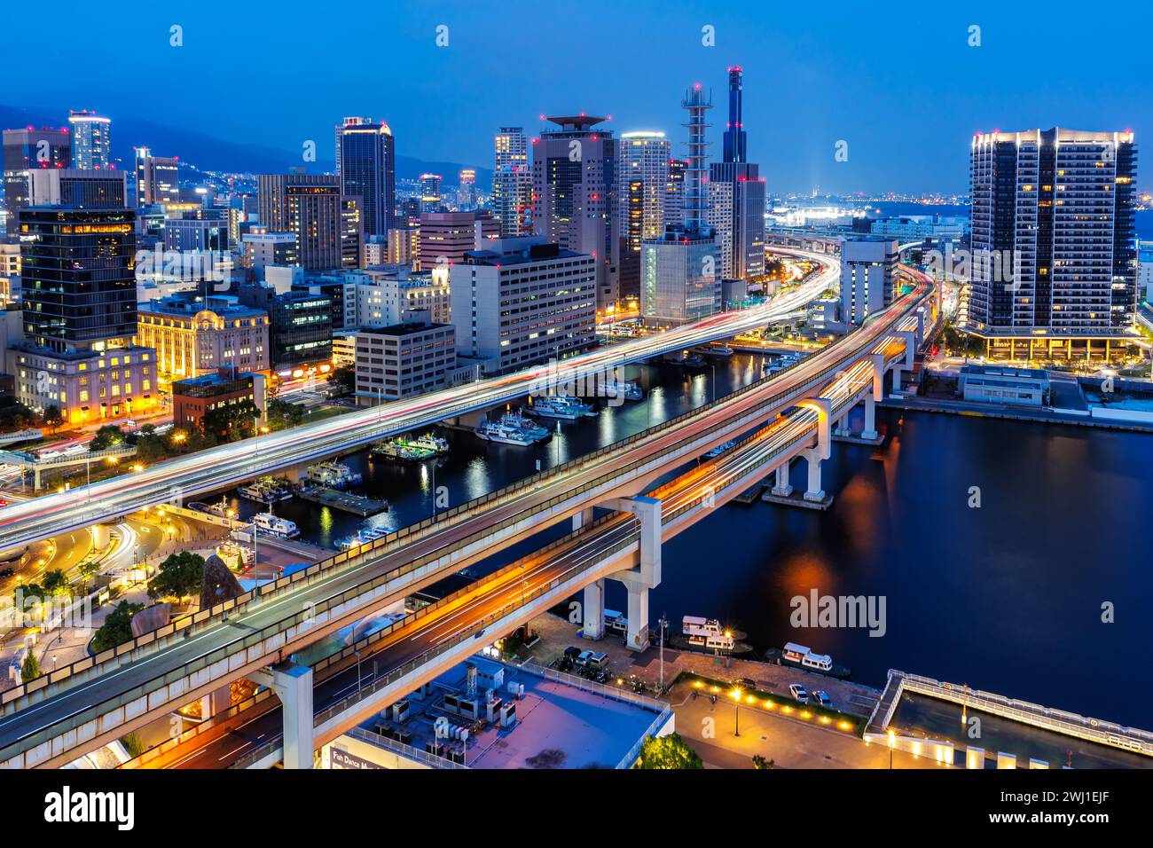 Kobe skyline from above with harbor and elevated roads at night in ...