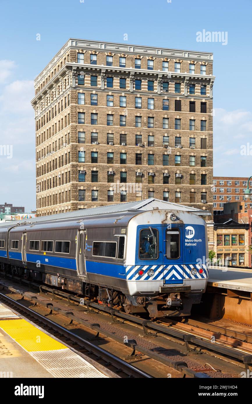 Metro-North Railroad commuter train at Harlem 125th Street station portrait format in New York ...