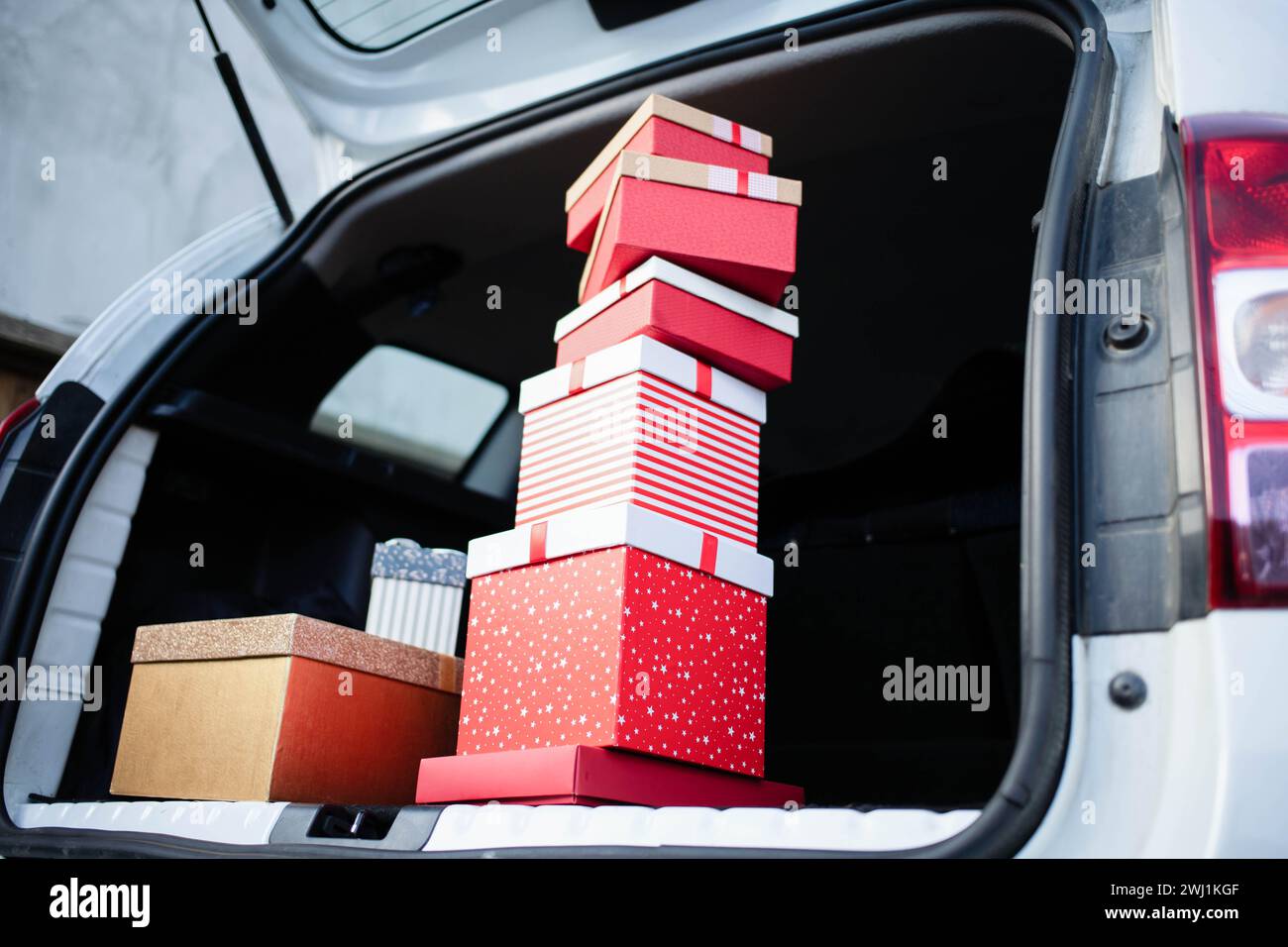 Pile of Christmas gift boxes in car Stock Photo - Alamy
