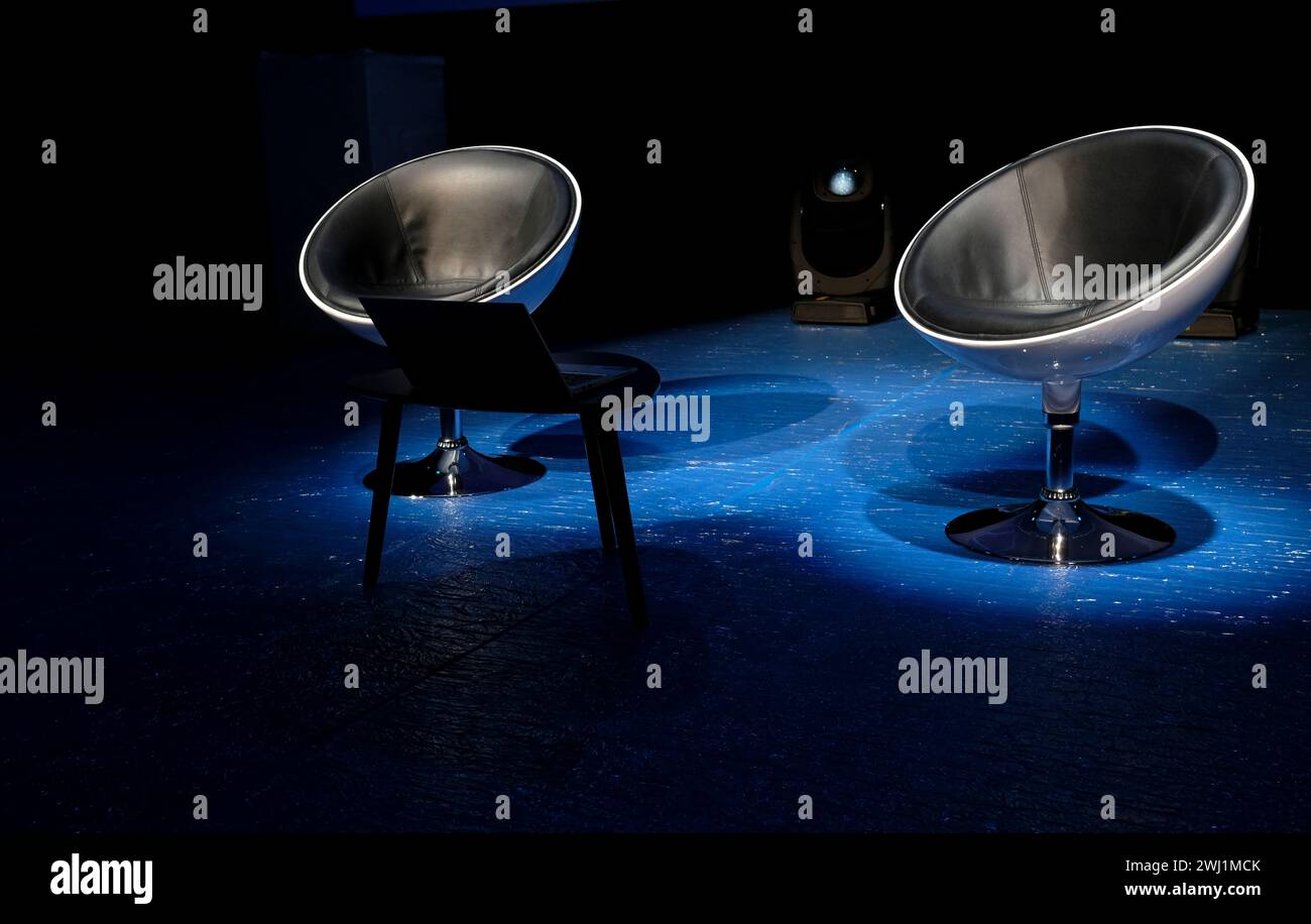 Debate or discussion - two empty chairs on stage with spotlights Stock ...