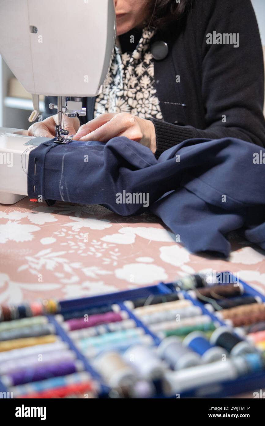 Detail of sewing work execution. Recycling clothes at home to reduce ...