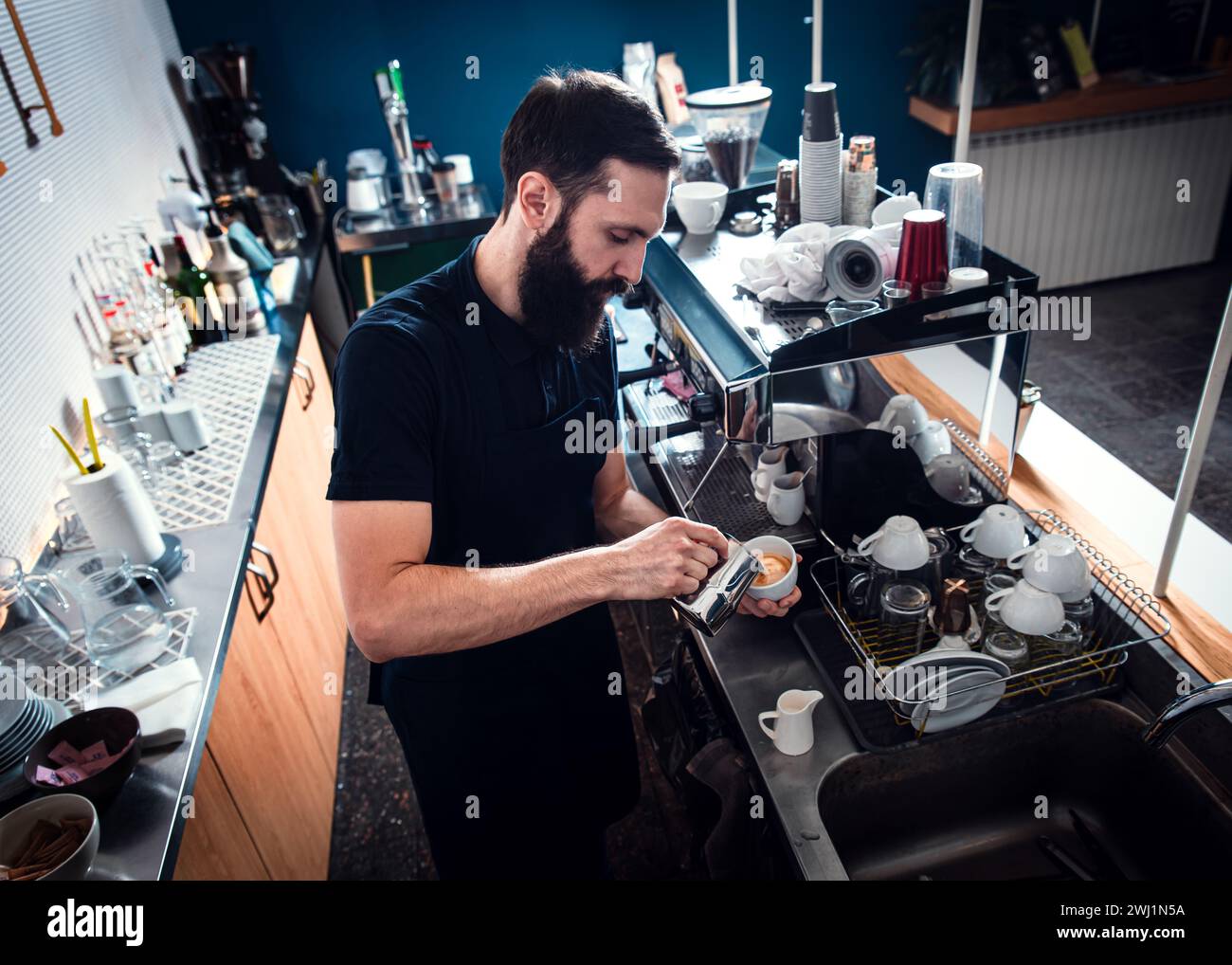 Barista preparing cappuccino on espresso machine for customer in coffee ...