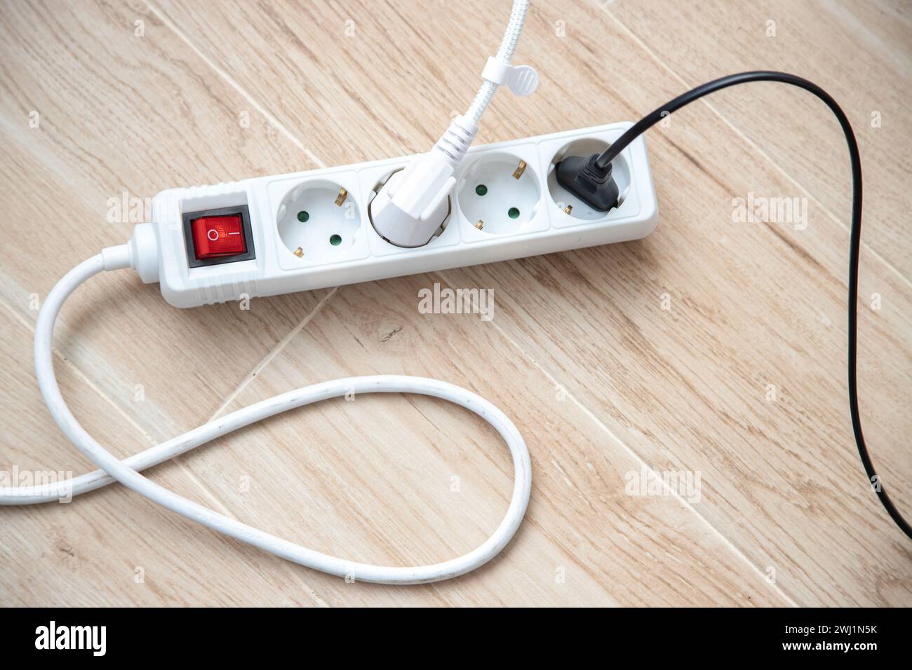 Electrical plug and multiple socket in use on the floor, Close up Stock ...