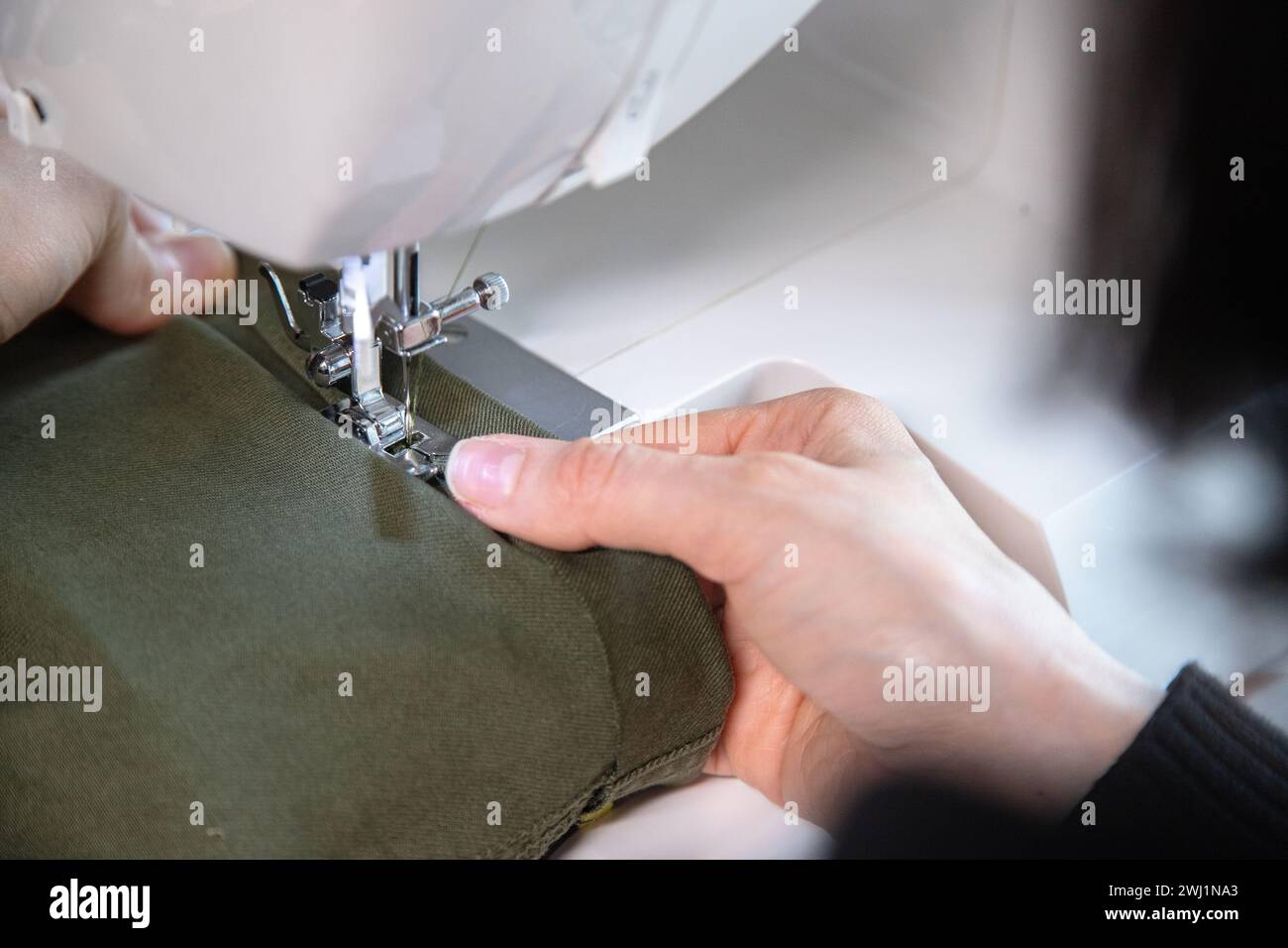Detail of sewing work execution. Recycling clothes at home to reduce ...
