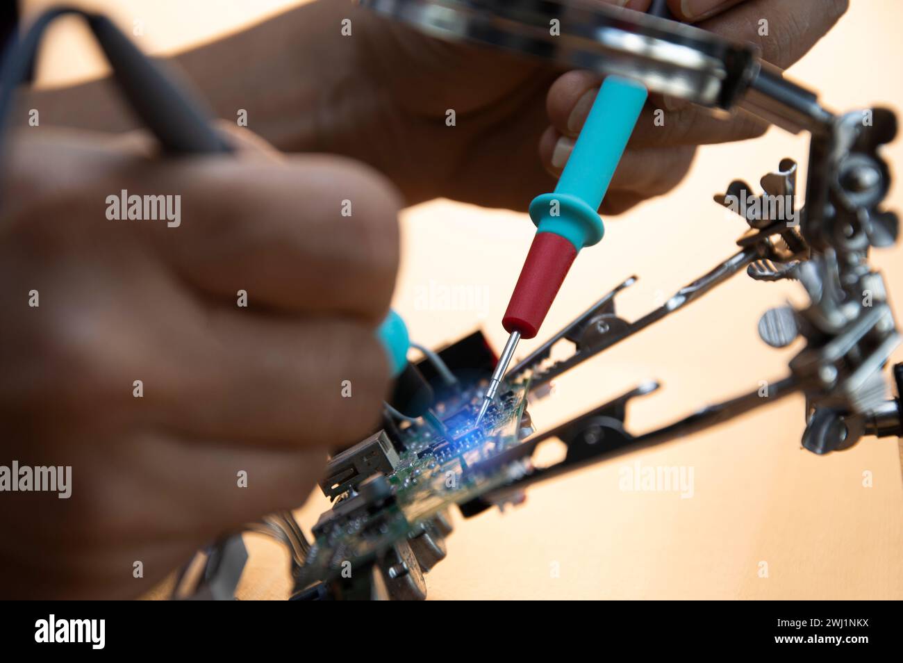 Technicians are repairing motherboards and checking electrical currents ...