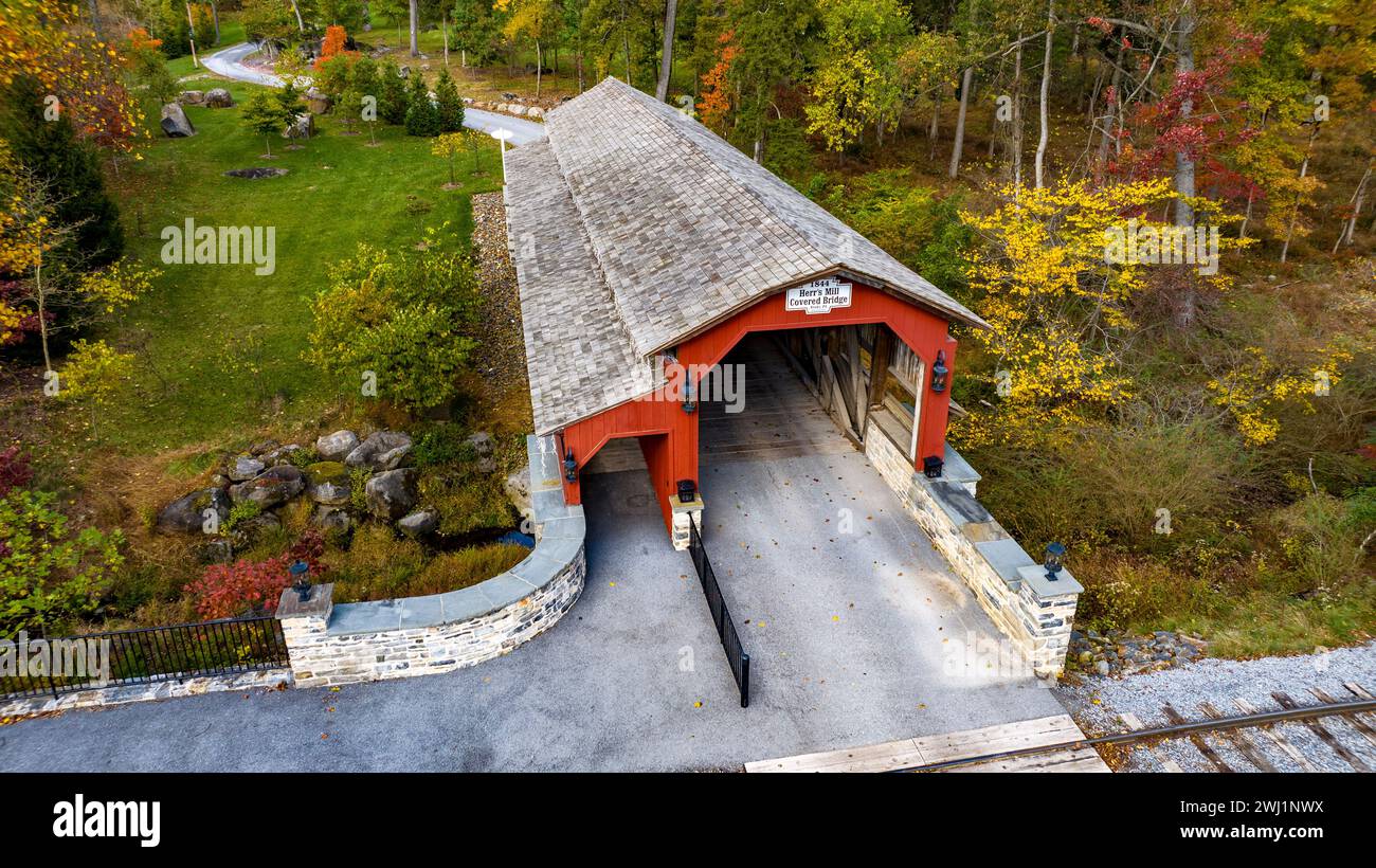 Aerial View of a Burr Truss Covered Bridge Crossing a Stream on an ...