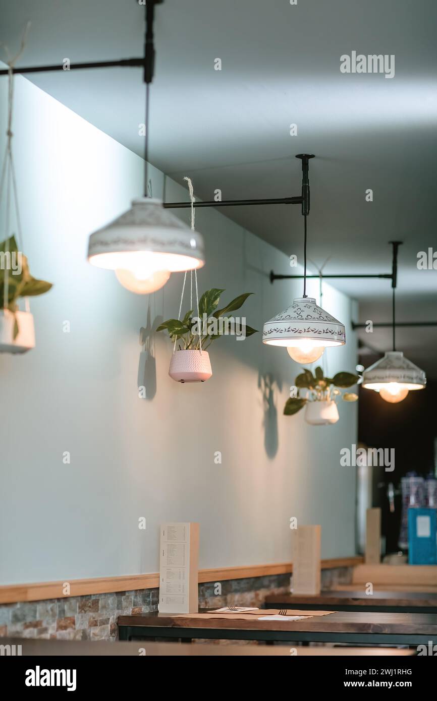 Stylish side view of a bar featuring designer white lamps, hanging ...