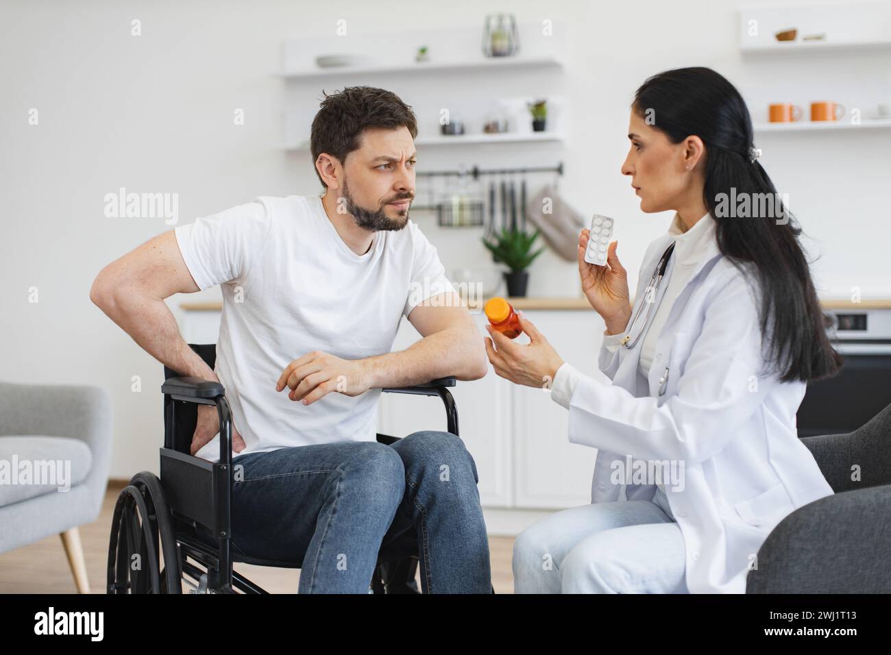 Doctor discussing health issues with caucasian male with pain in lower ...
