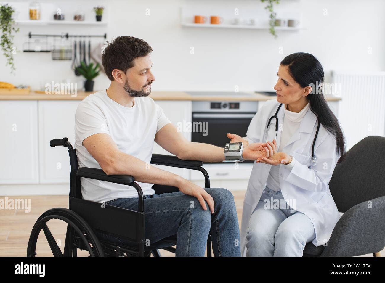Female doctor and patient with disability having talk about diagnosis ...