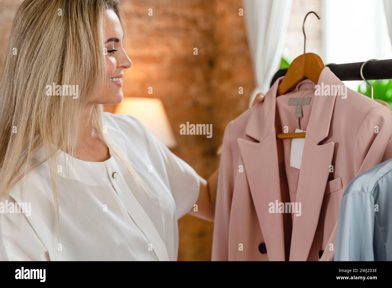 Woman checking quality of fabric in clothing store Stock Photo - Alamy