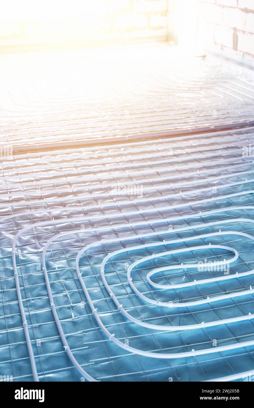 Underfloor heating pipes installation on construction site Stock Photo ...