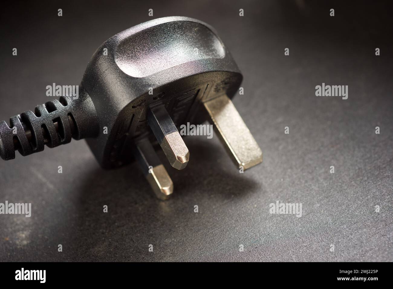 Close up on a table of a black plug used in the United Kingdom Stock ...