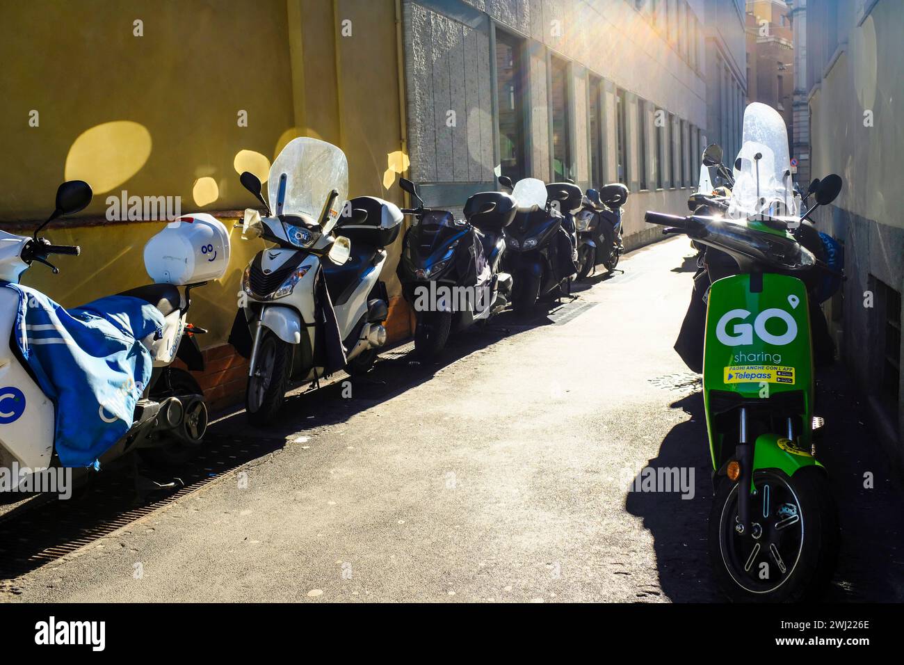 a narrow lane with moto parked Stock Photo - Alamy