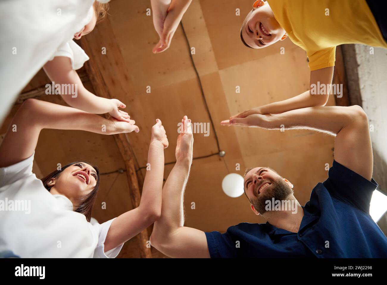 Parents and children packing backpacks at home, giving high five ...