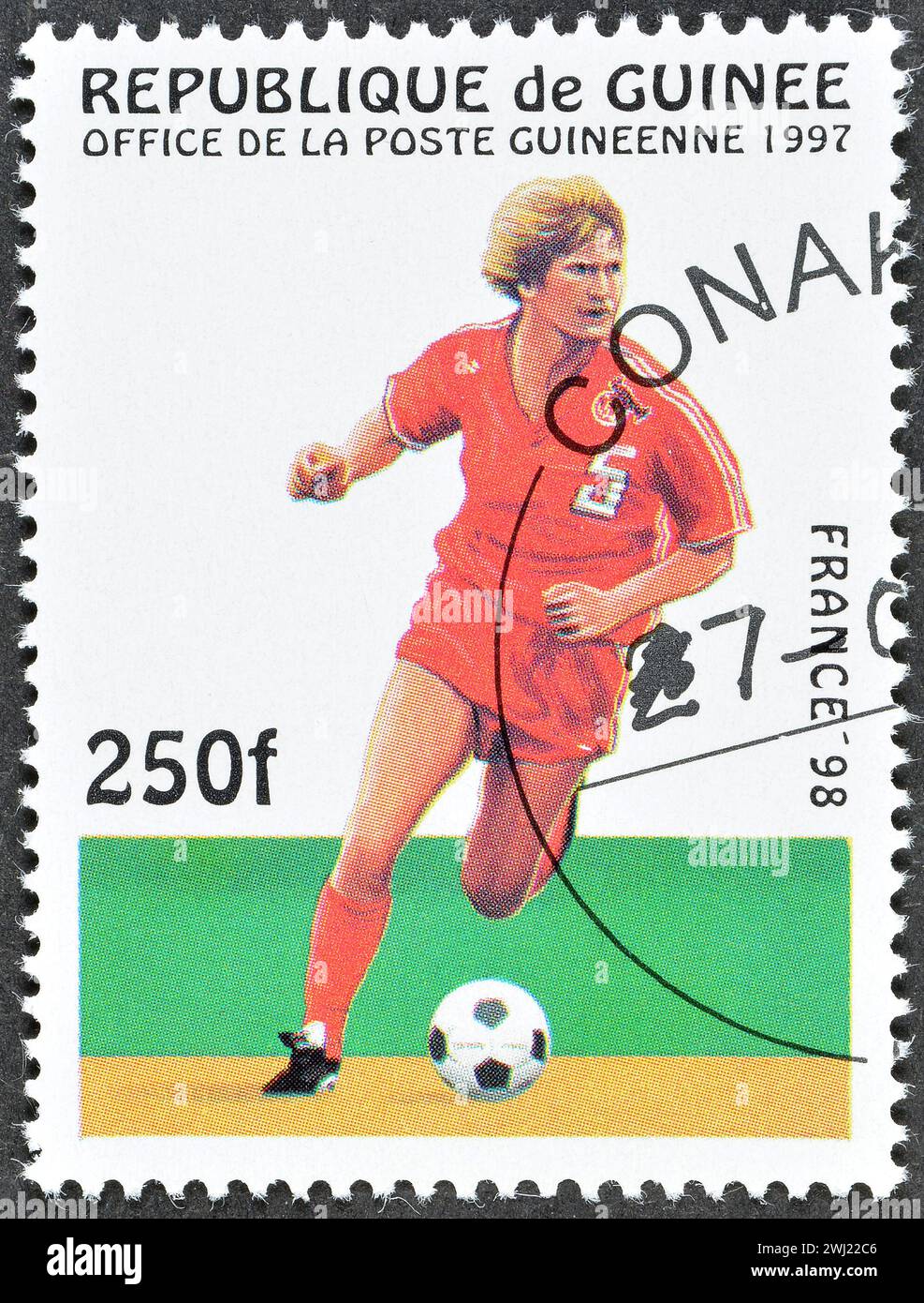 Cancelled postage stamp printed by Guinea, that shows Football players ...