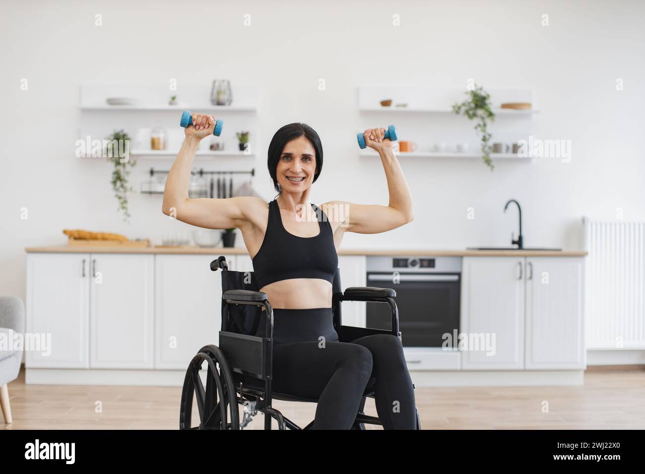 Caucasian person with disability holding dumbbells in raised arms Stock ...