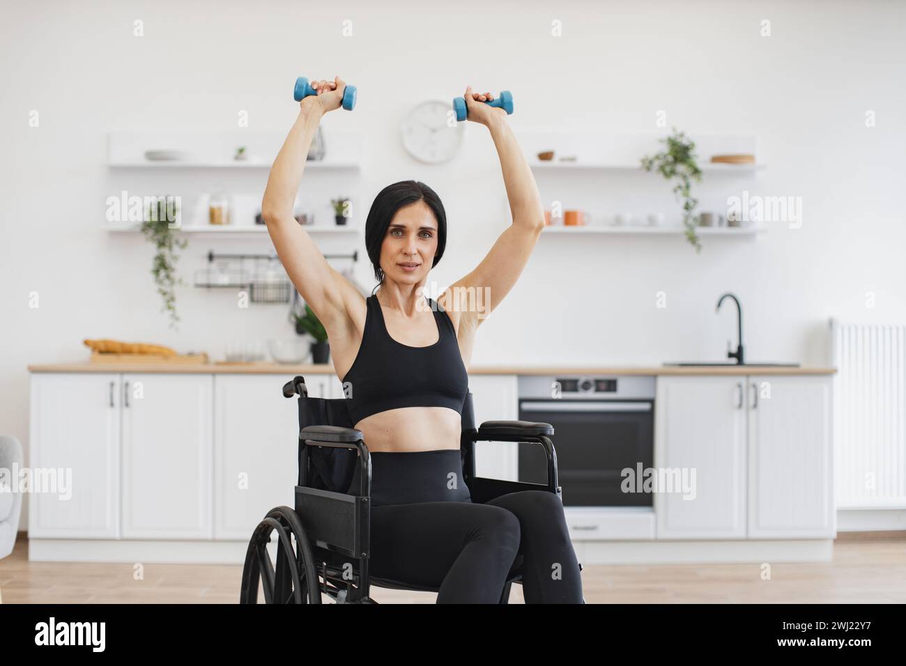 Caucasian person with disability holding dumbbells in raised arms Stock ...