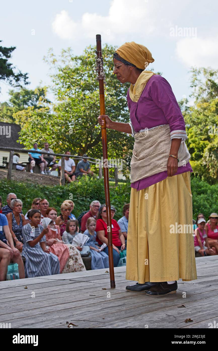 historic interpreter, woman, black slave, colonial dress, holding staff ...
